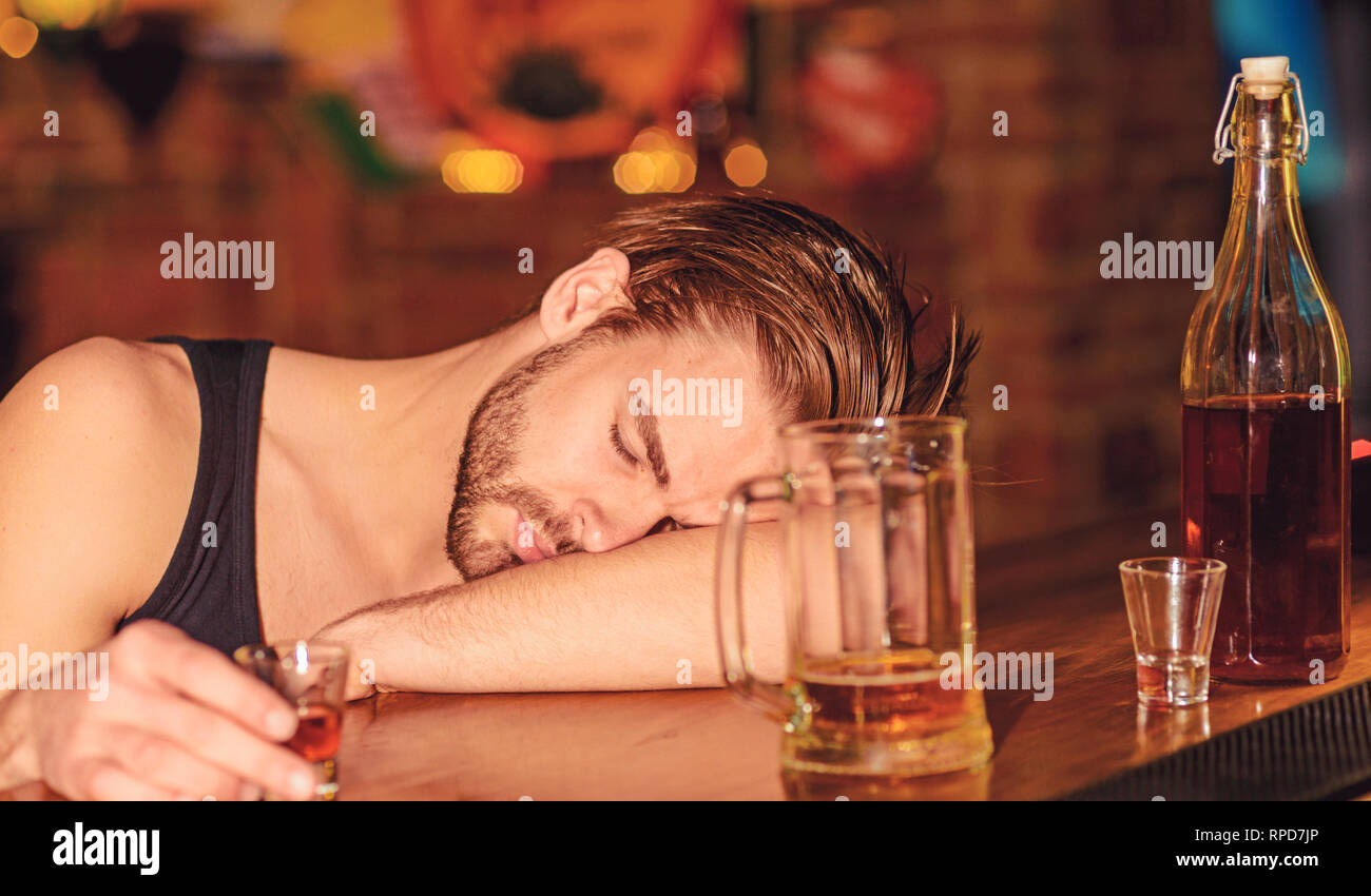 He should be concerned about his habit. Alcoholic man sleeping at bar ...