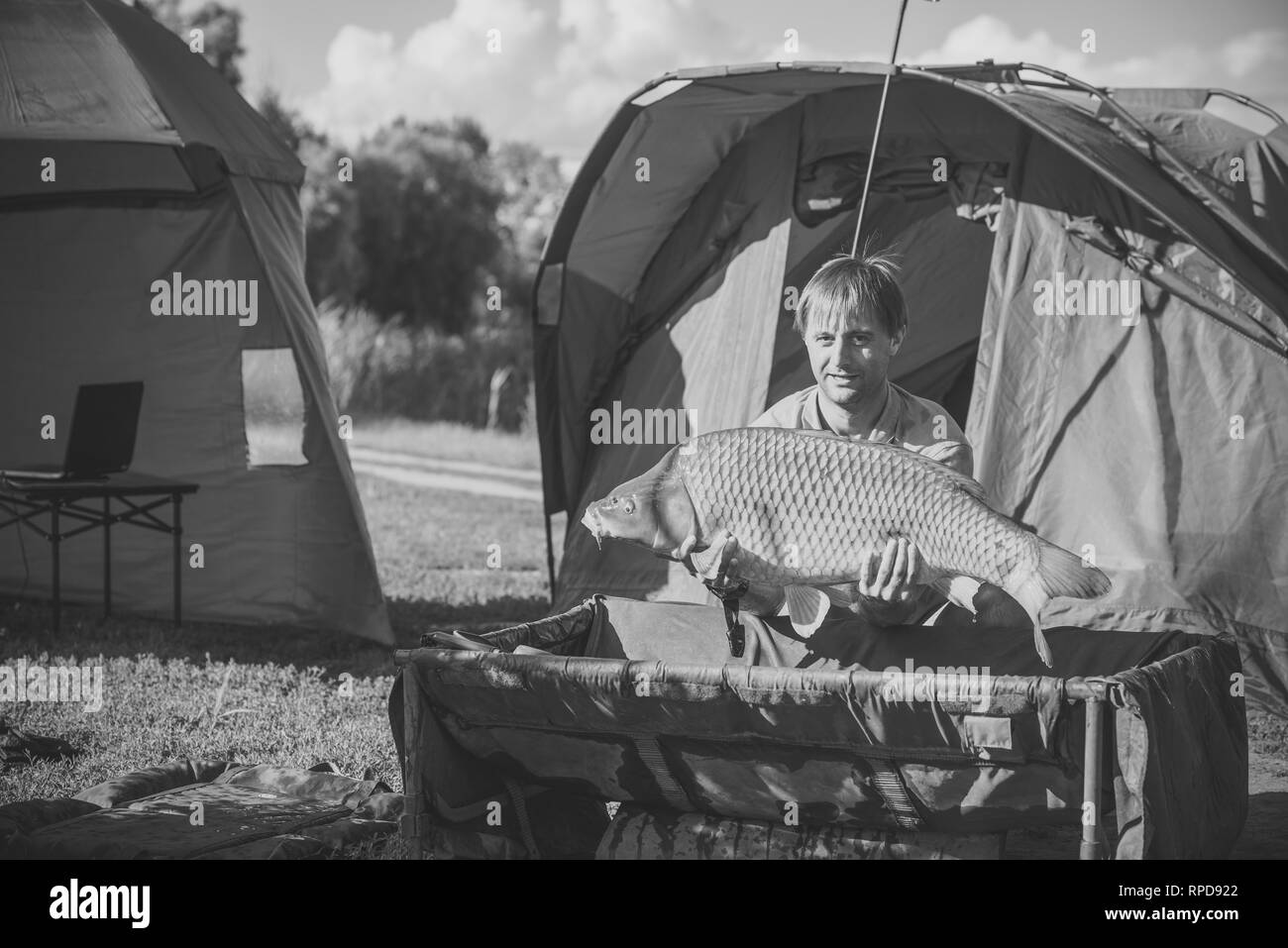 Happy angler with carp fishing trophy Stock Photo - Alamy