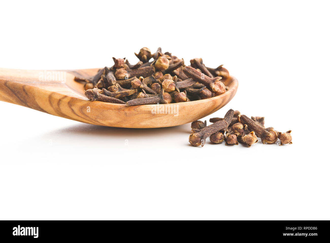 Carnation, dried clove spice in wooden spoon isolated on white ...