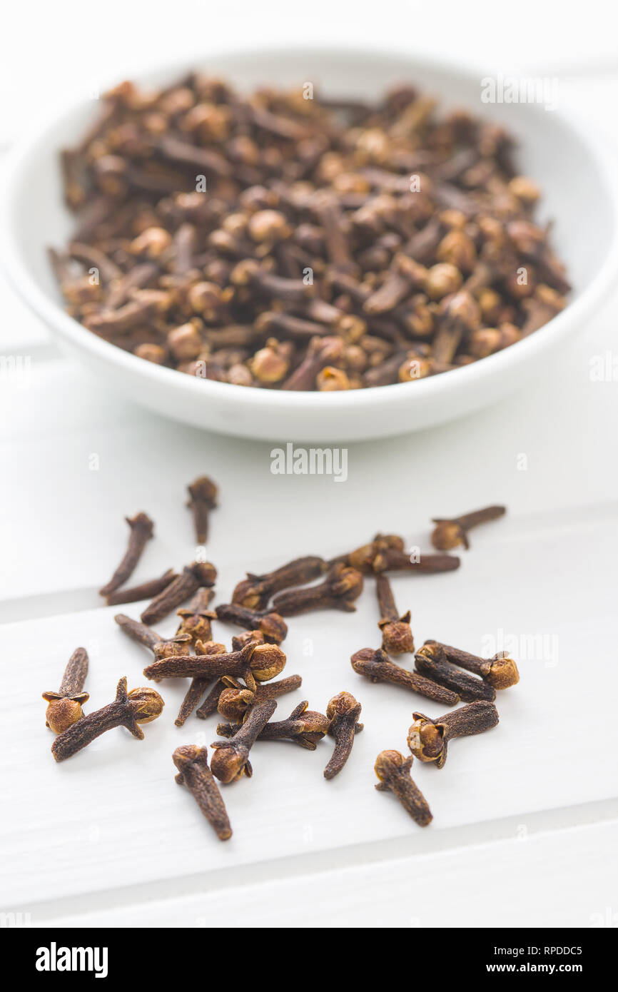 Carnation, dried clove spice on white table Stock Photo - Alamy