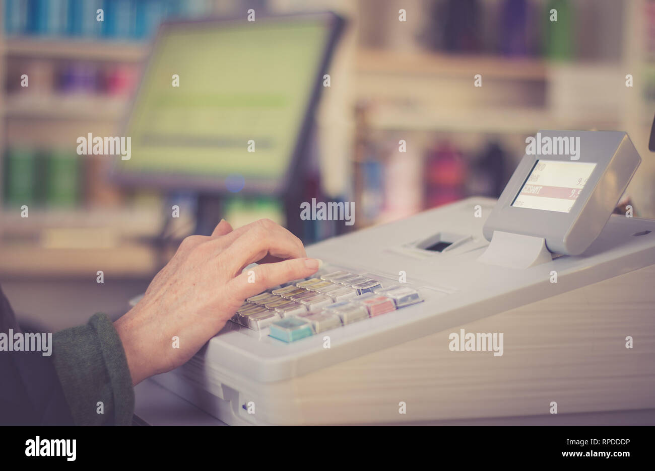 Cash register in a shop: Customer is paying purchase Stock Photo - Alamy