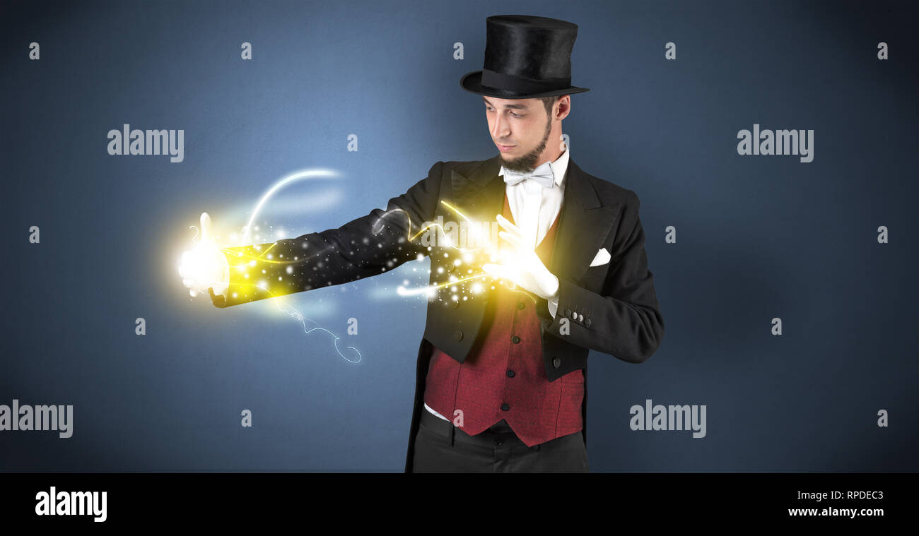 Magician holding his sparkling power between his two hand Stock Photo ...