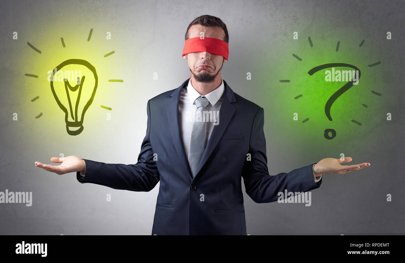 Covered eye businessman with bulb and question sign symbols around ...