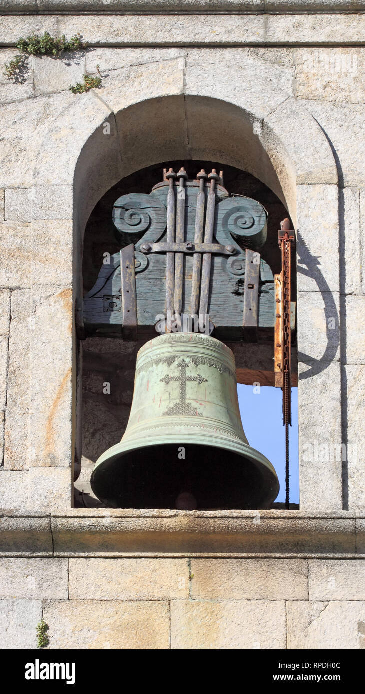 Old bronze decorated bell in a granite church of the north of Portugal ...
