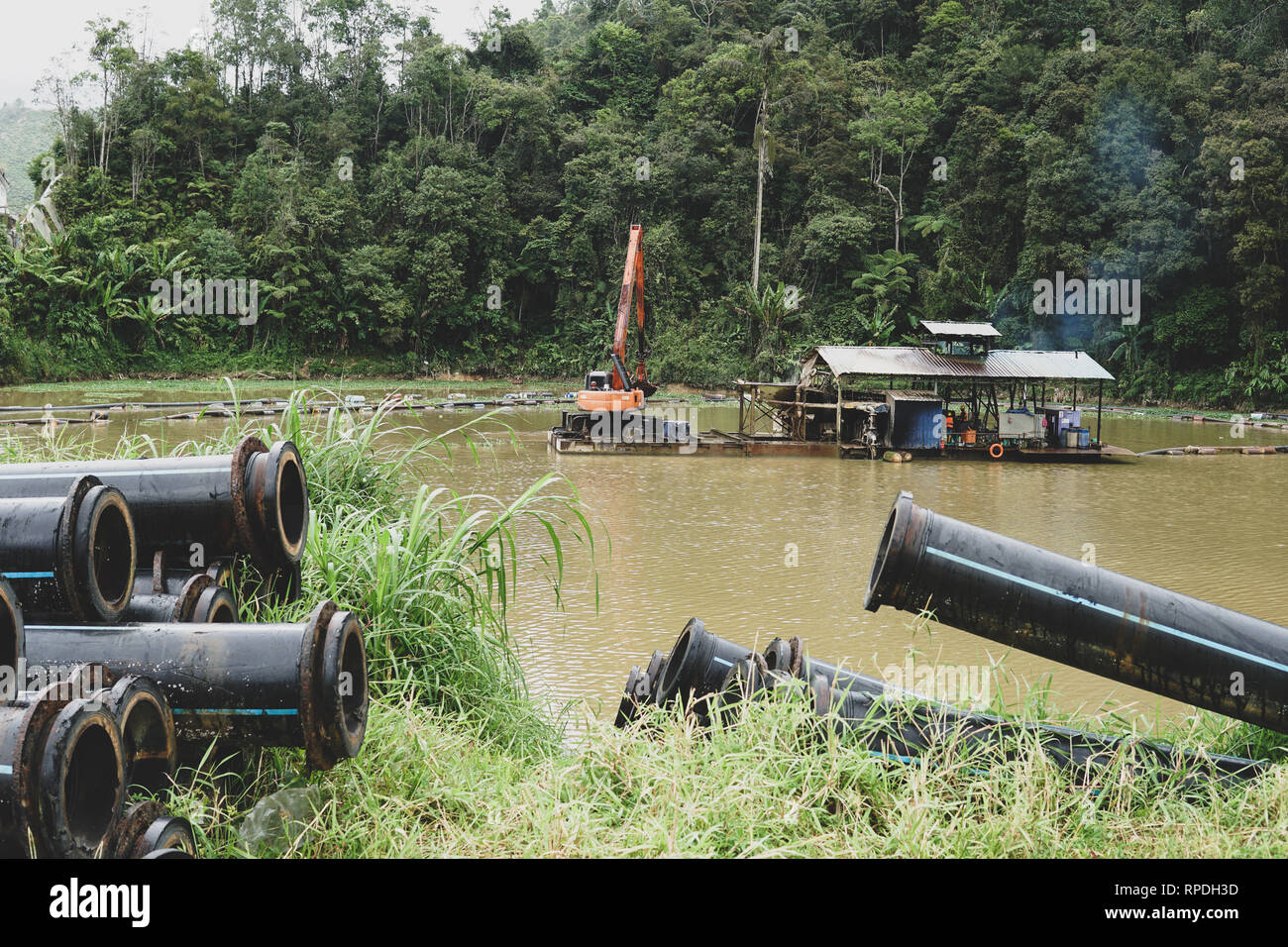 Sand dredging boat ,pump and excavator removing sand from the river bed ...