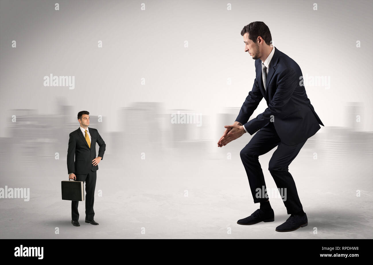 Giant businessman being afraid of small serious executor with suitcase ...