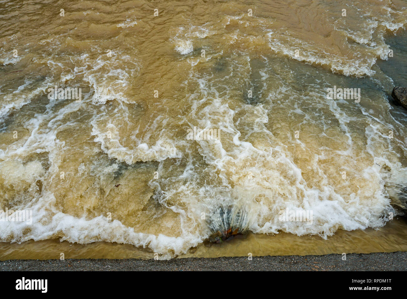 View of muddy river rapid and turbulent currents in Malaysia River ...
