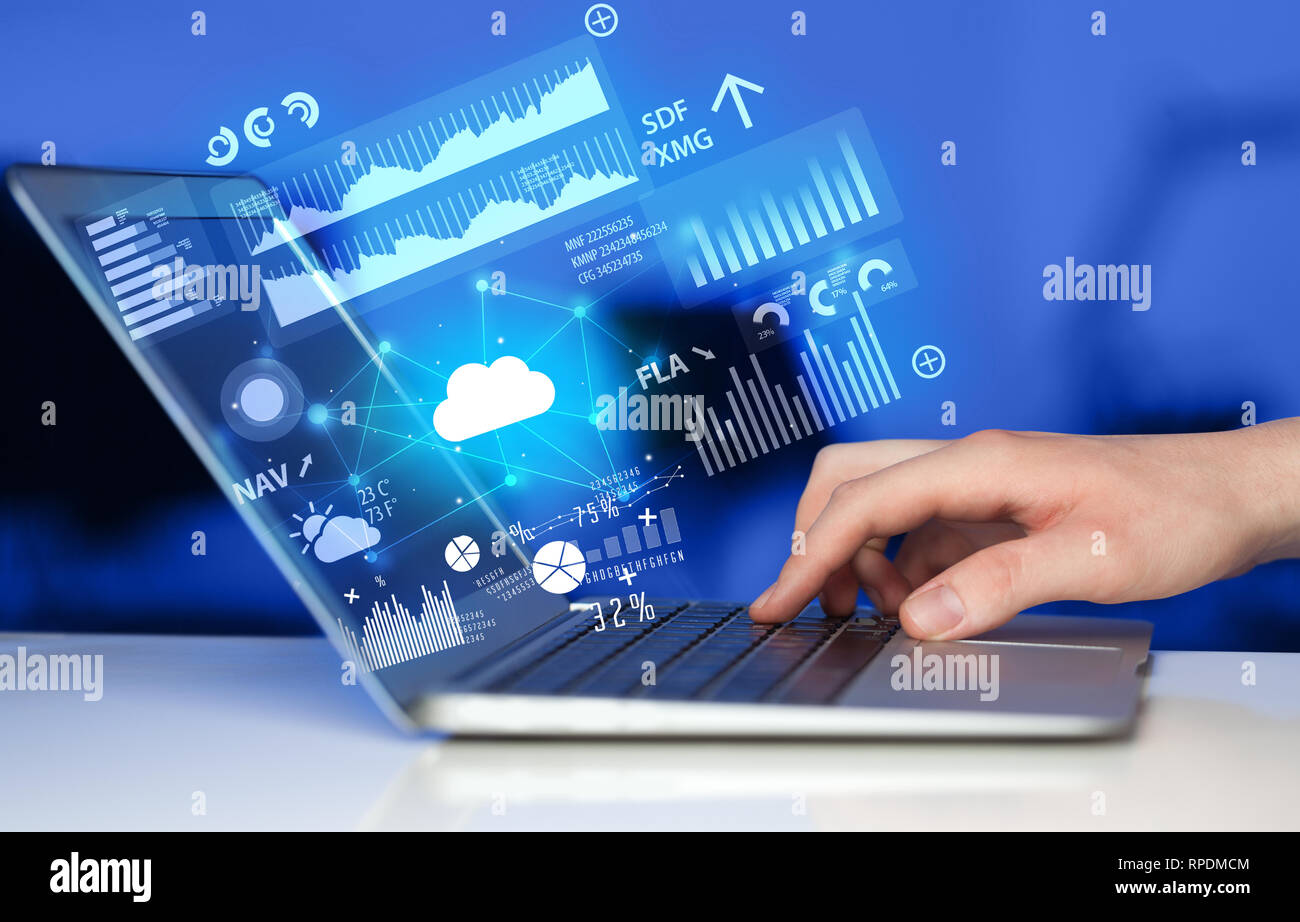 Hand using laptop with cloud technology and linked information concept ...