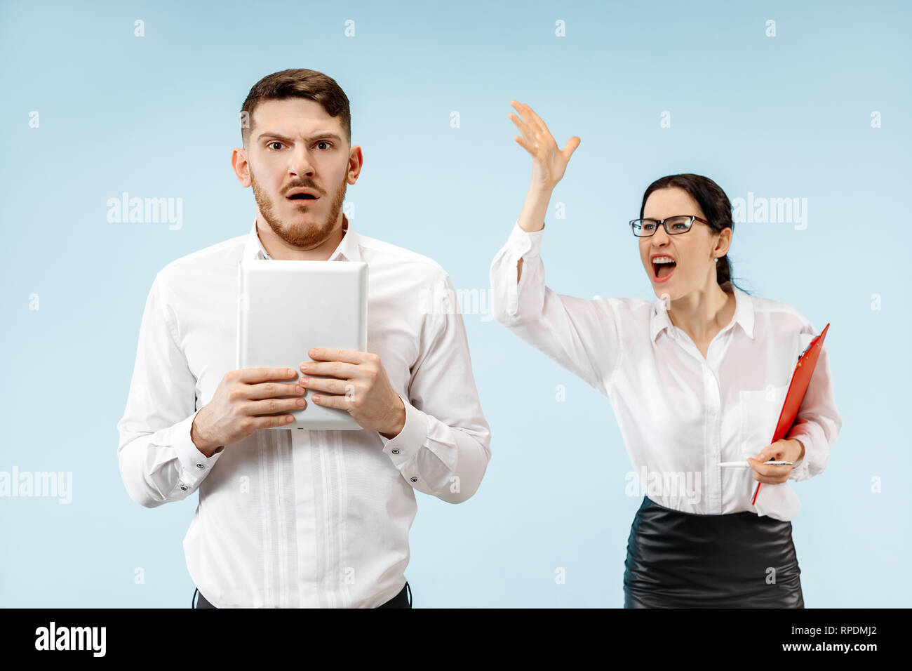 Angry boss. Woman and his secretary standing at office or studio ...