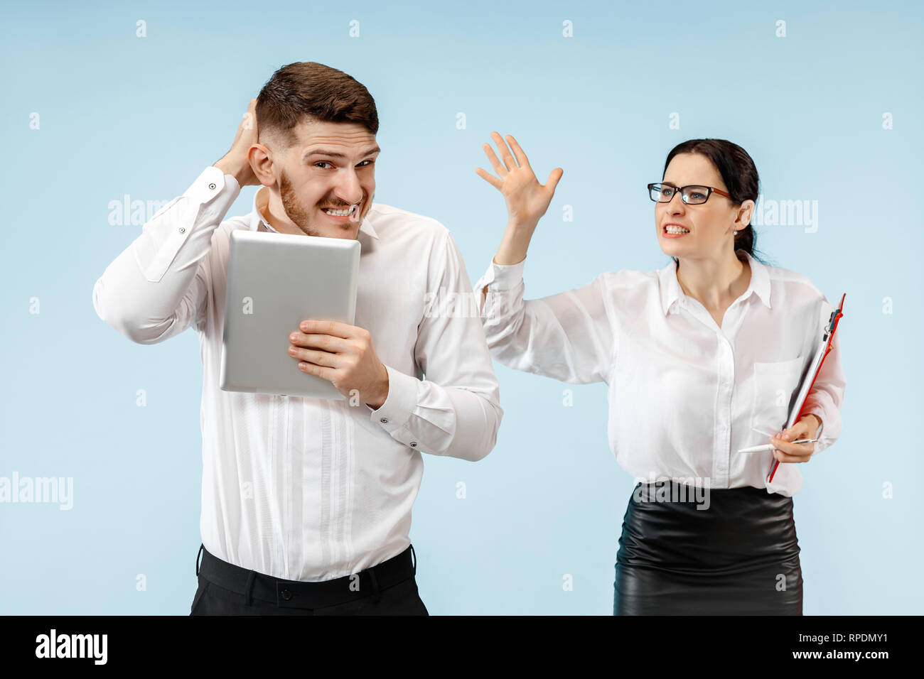 Angry boss. Woman and his secretary standing at office or studio ...