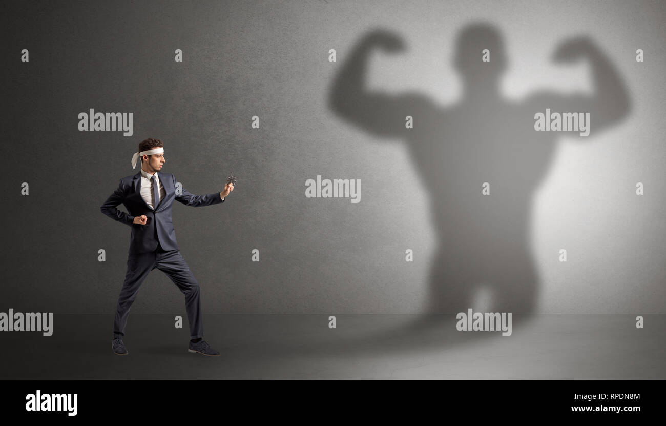 Young karate man fighting with a big black scary shadow Stock Photo - Alamy