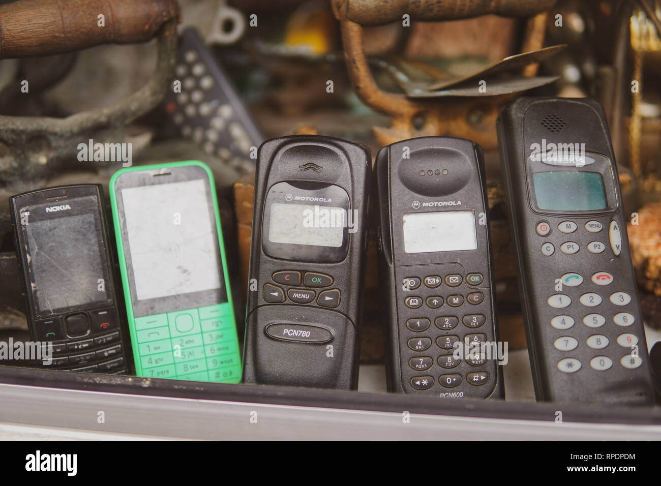 Old and obsolete mobile phone or cell phones on space of old wood ...