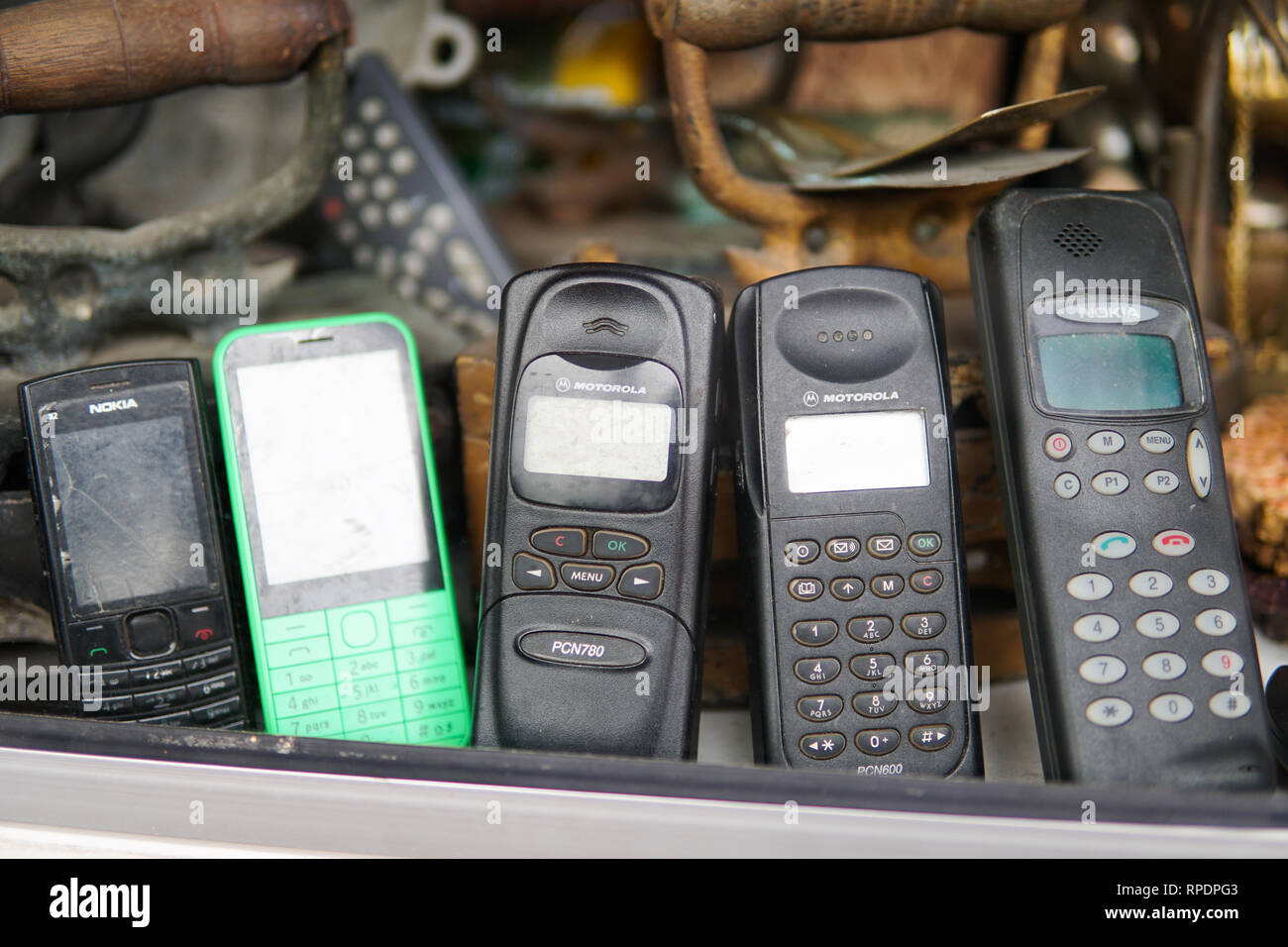 Old and obsolete mobile phone or cell phones on space of old wood ...