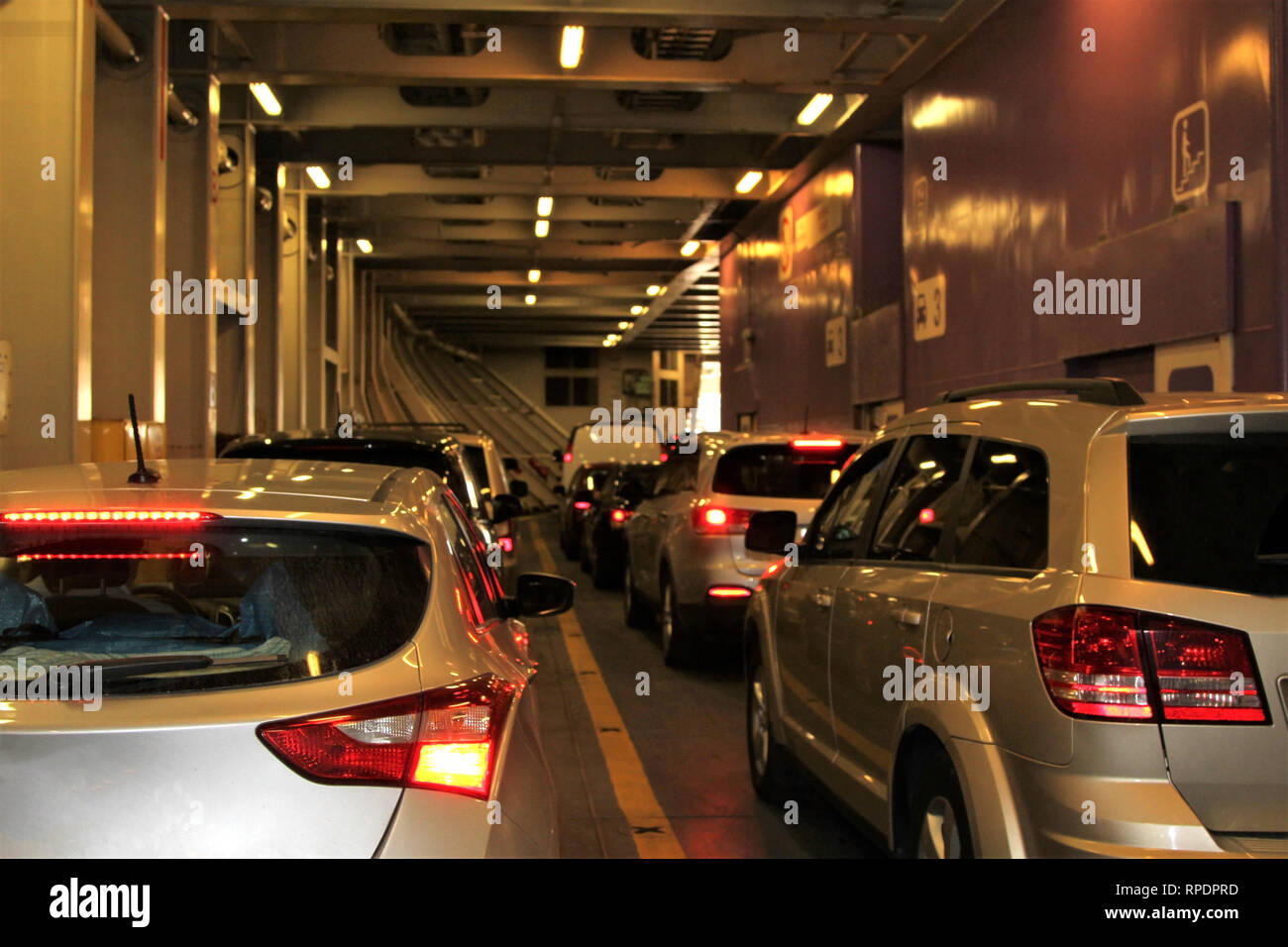 Passenger cars inside a ferryboat ship being transported to ...