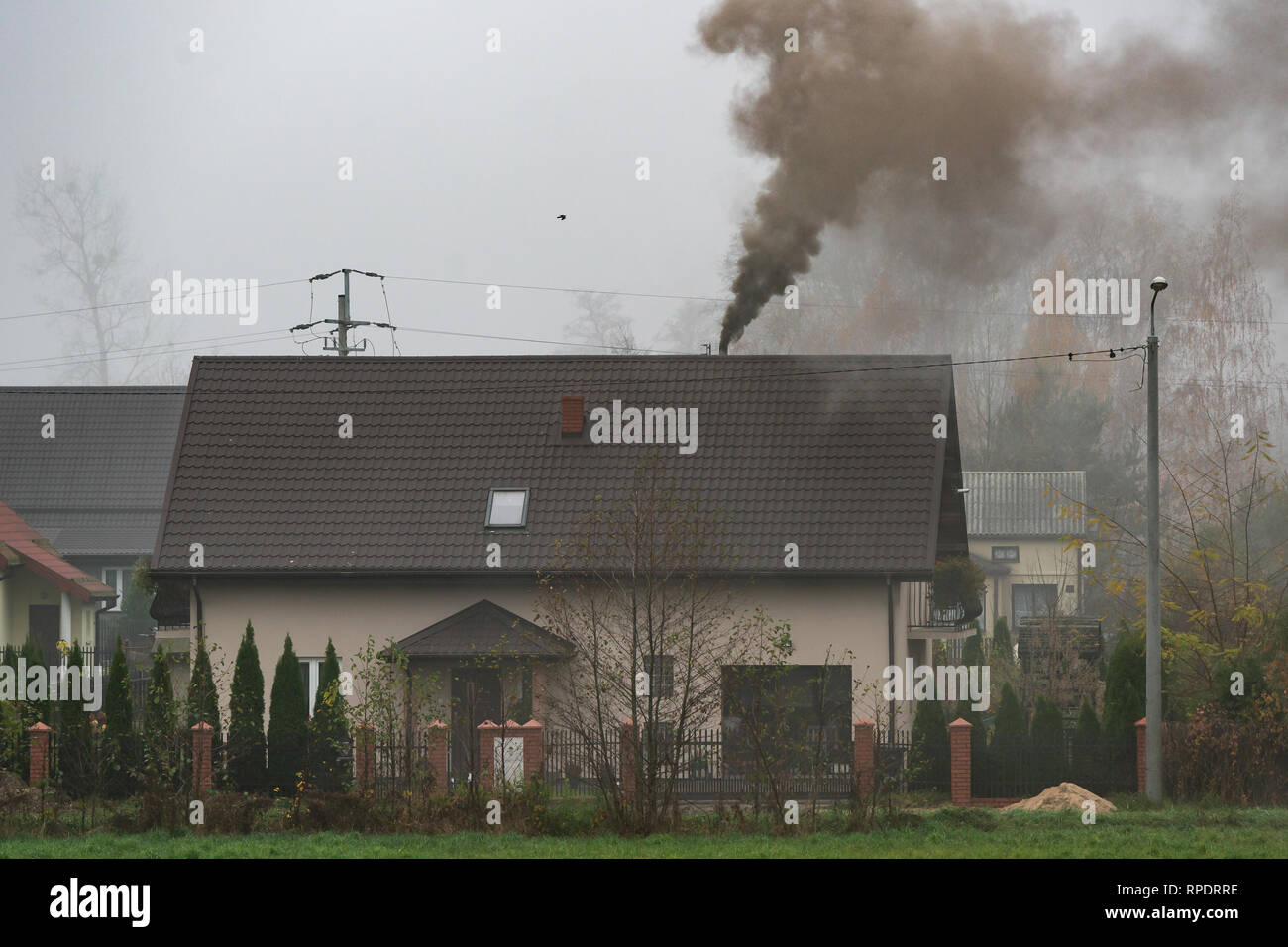 smoke floating above the house - poisoning the environment Stock Photo ...