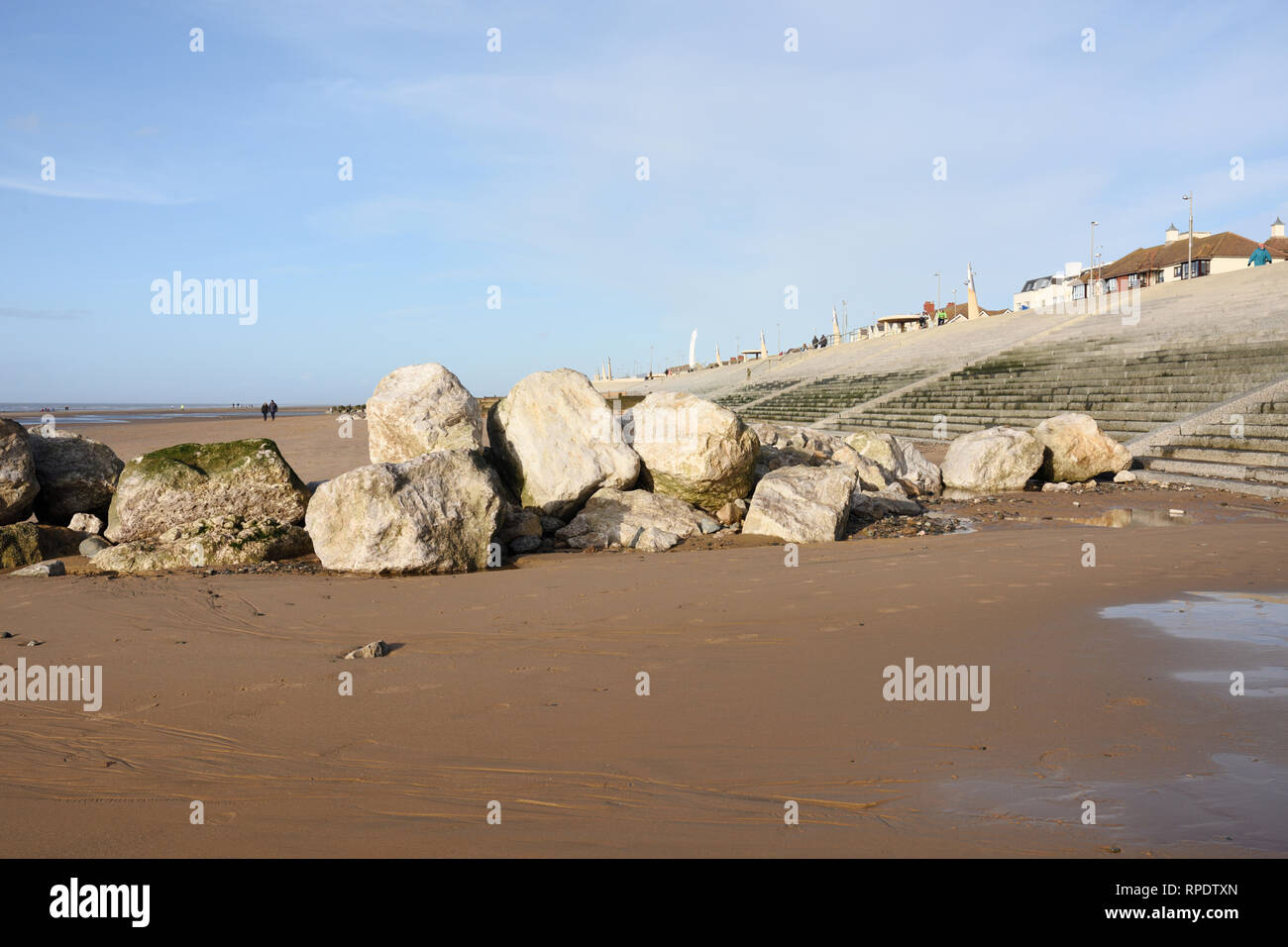 Rock armour and concrete stepped revetment in the background on ...