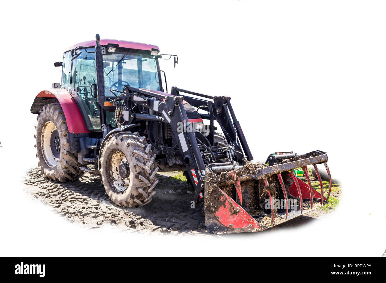 General view of a powerful tractor with a front loader for manure mixed ...