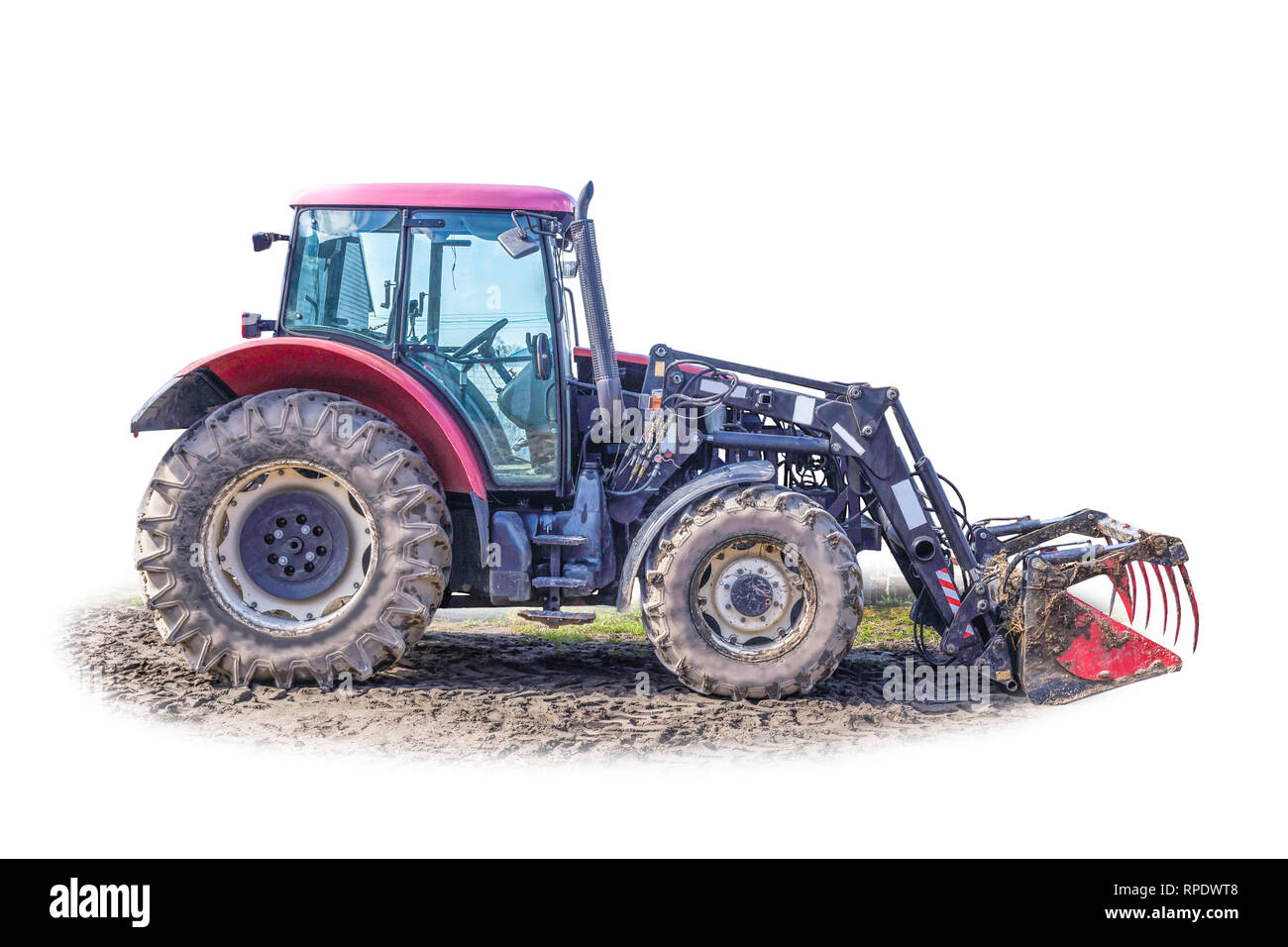 Side view of a powerful tractor with a front loader for manure mixed ...