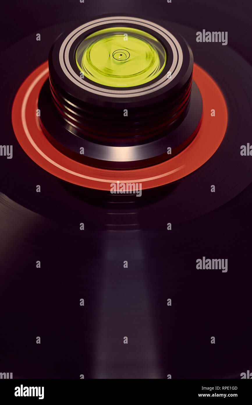 Vertical background of a rotating record and weight with a centered ...