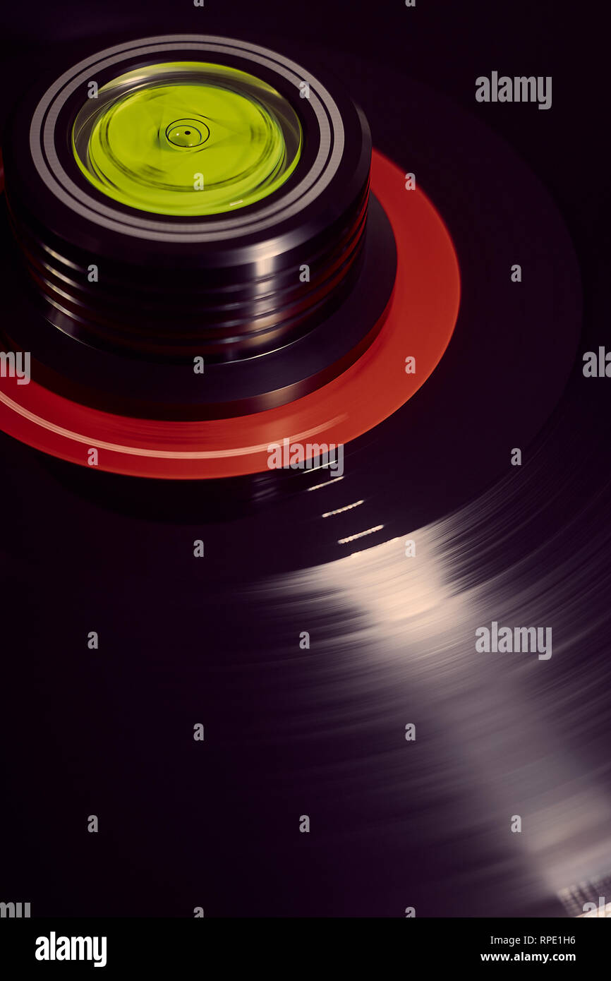 Vertical background of a rotating record and weight with a strong ...