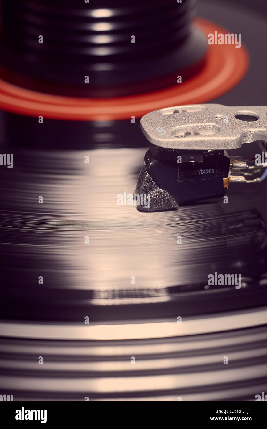 Vertical background of a rotating record and weight with the stylus ...