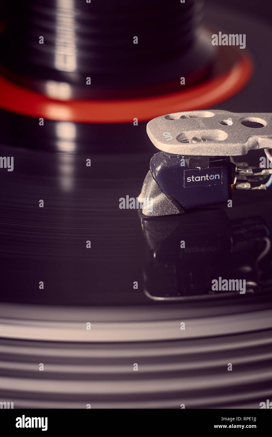 Vertical background of a rotating record and weight with the stylus ...