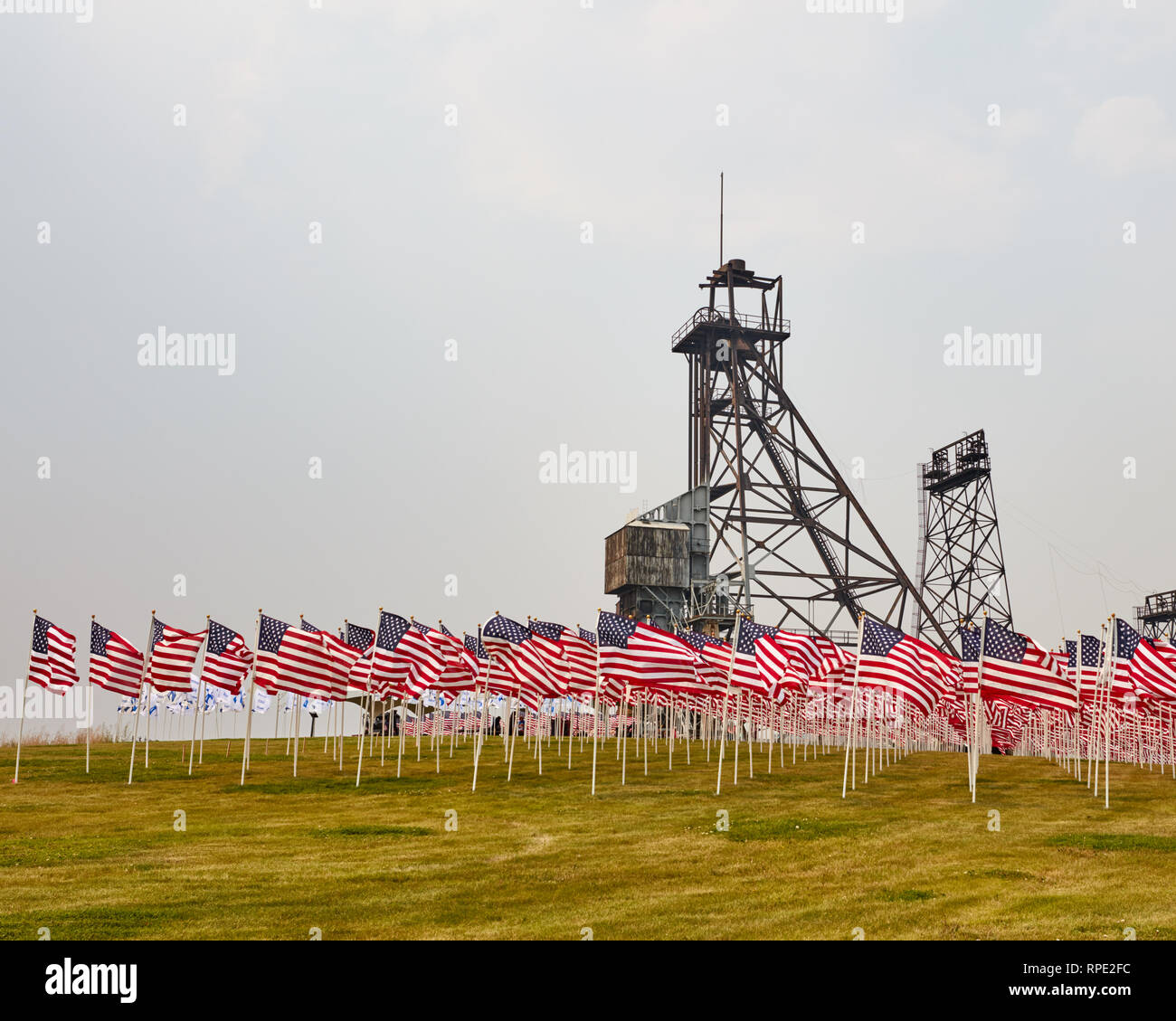 A copper mine head frame standing behind a field of honor made up of ...