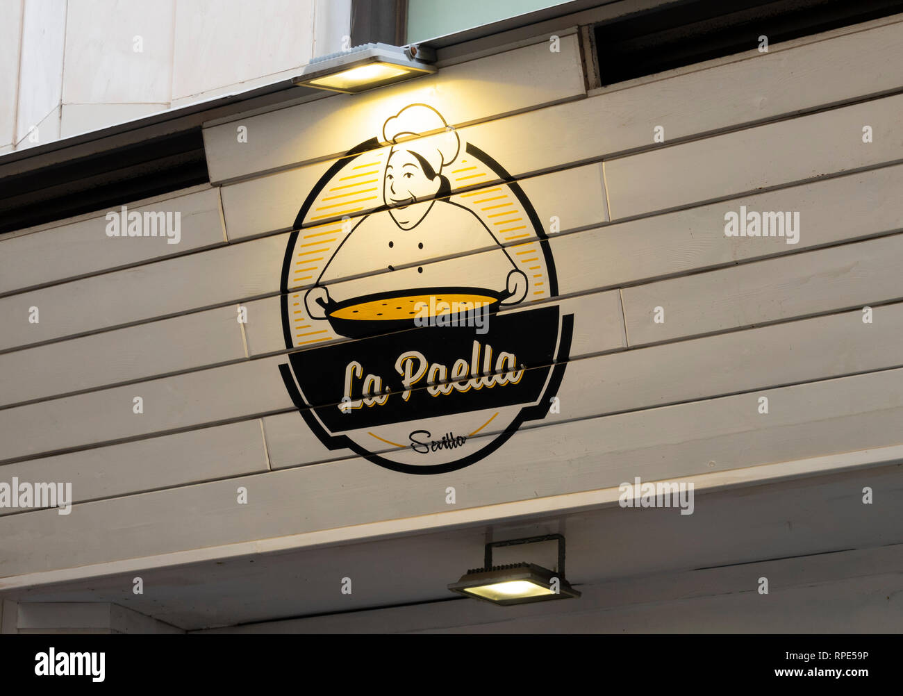 Sign above entrance to La Paella Seville Stock Photo - Alamy