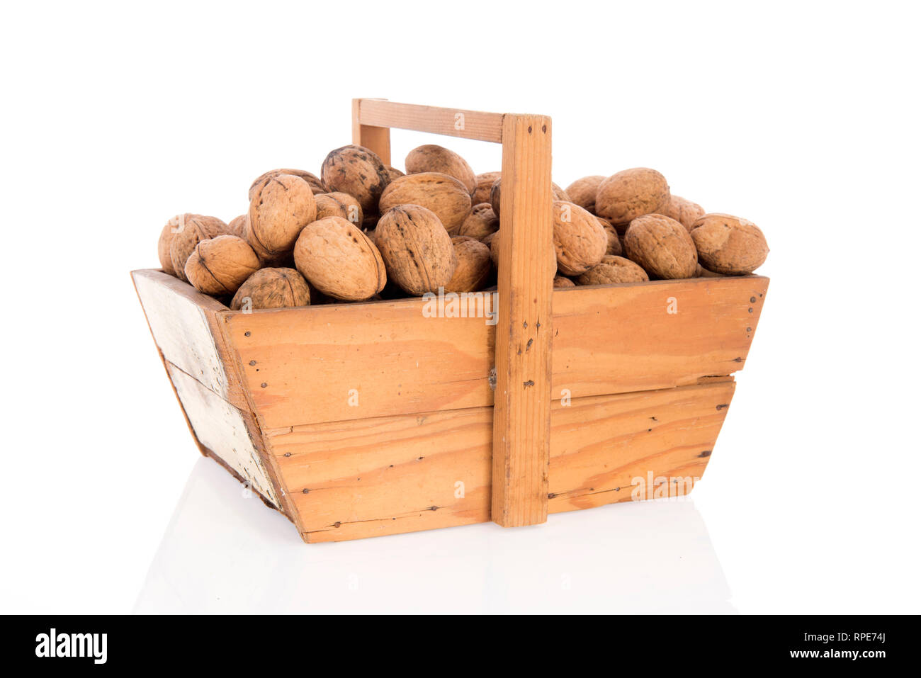 Wooden harvest baskets full walnuts isolated over white background ...
