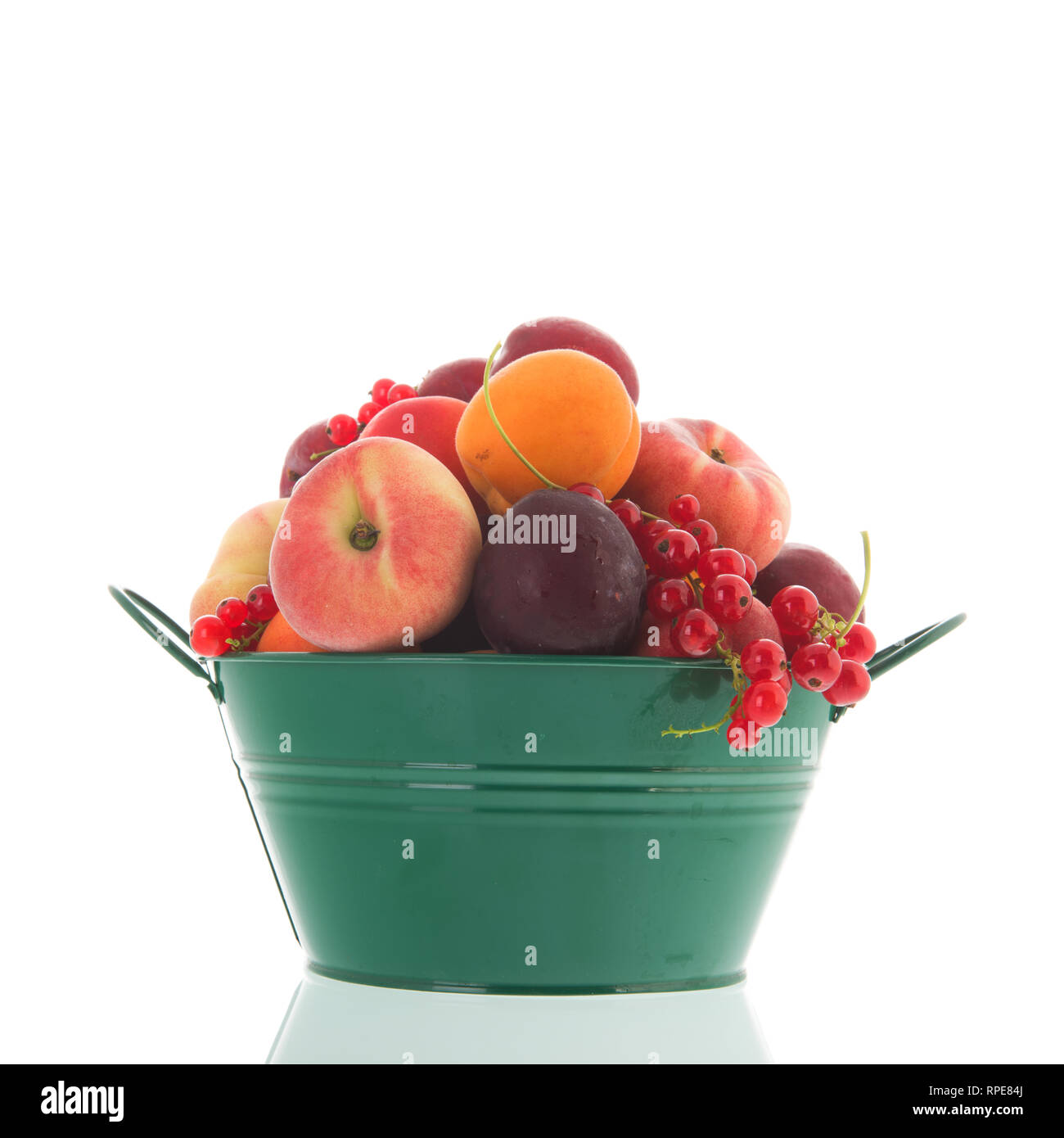 Green bucket full with fresh fruit isolated over white background Stock ...
