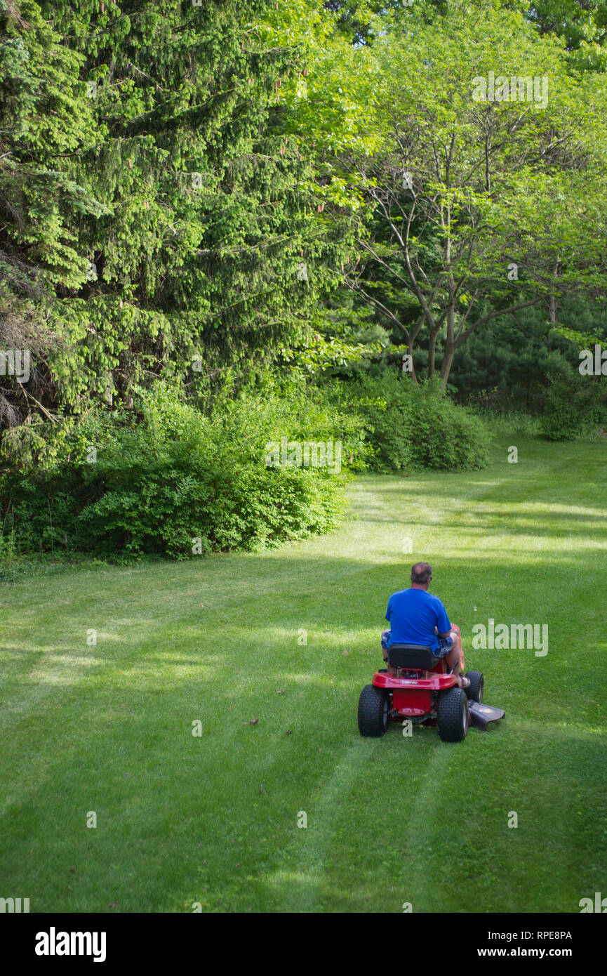 Person mowing the grass hi-res stock photography and images - Alamy