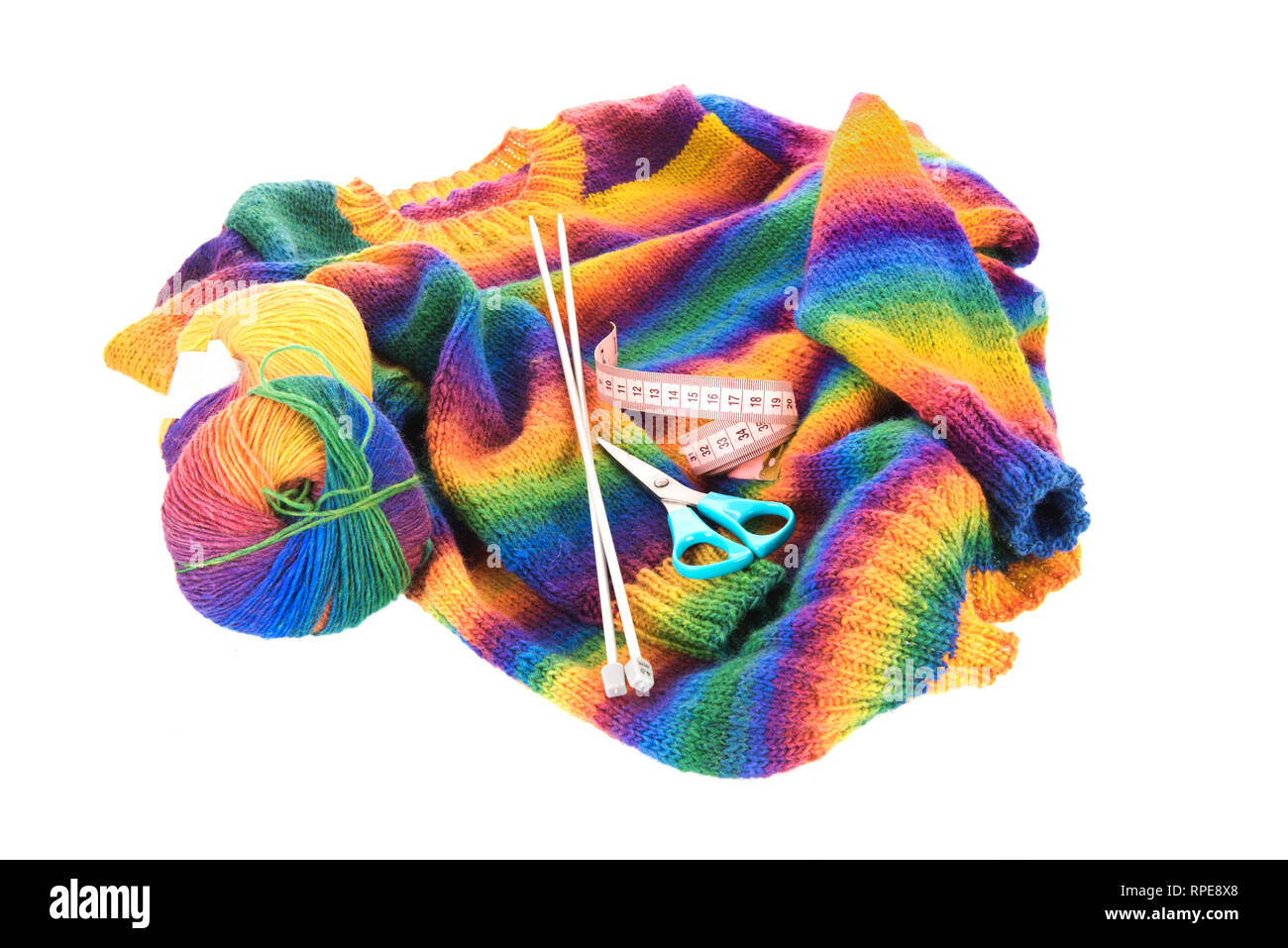 Colorful knitted jumper with needles and wool isolated over white ...