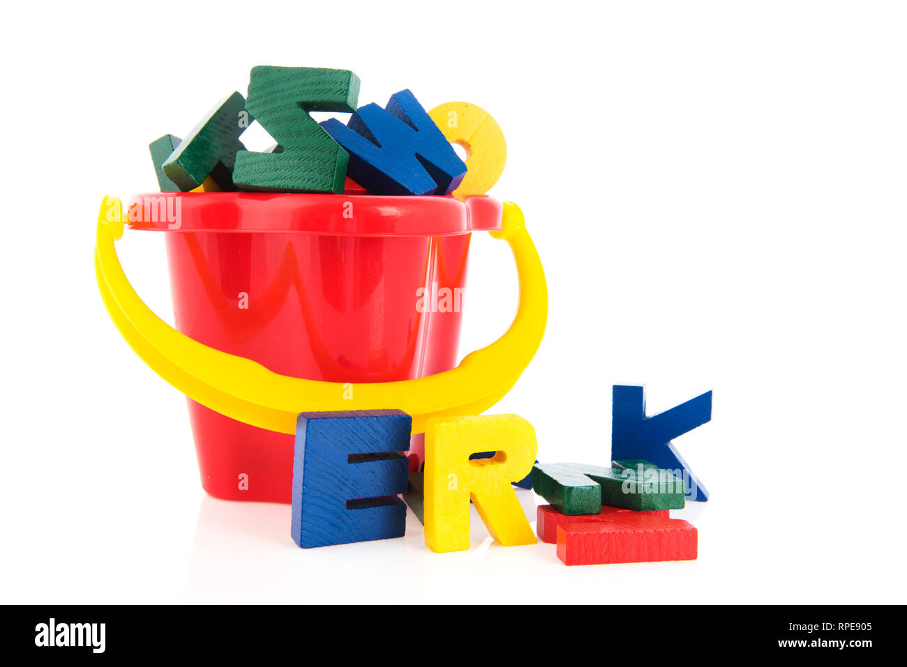 Many vintage wooden letters in toy bucket isolated over white ...