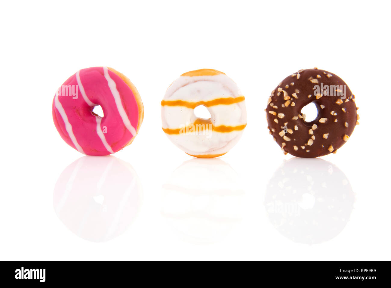 Three donuts in pink, white and chocolate Stock Photo - Alamy
