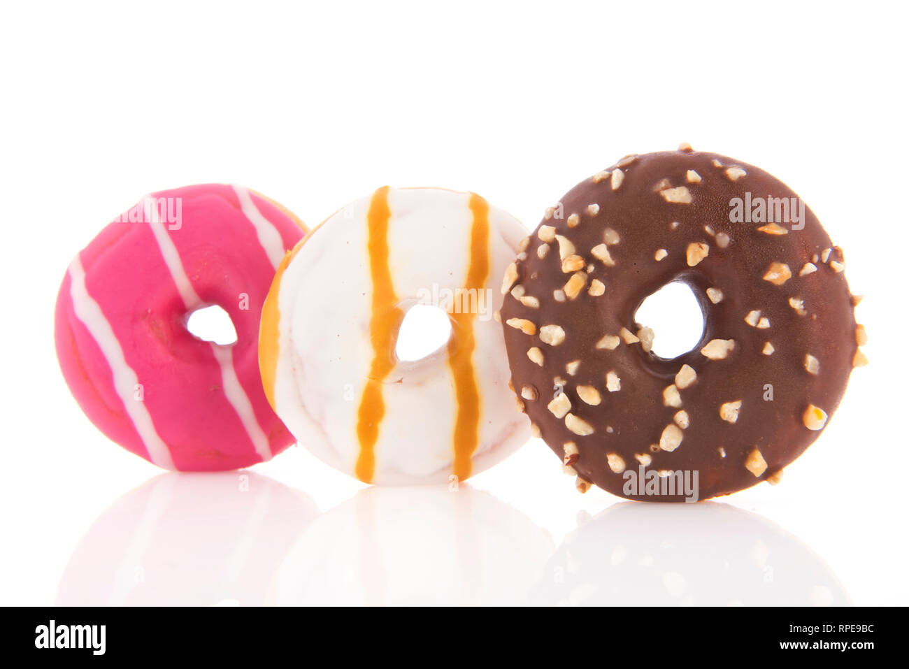 Three donuts in pink, white and chocolate Stock Photo - Alamy