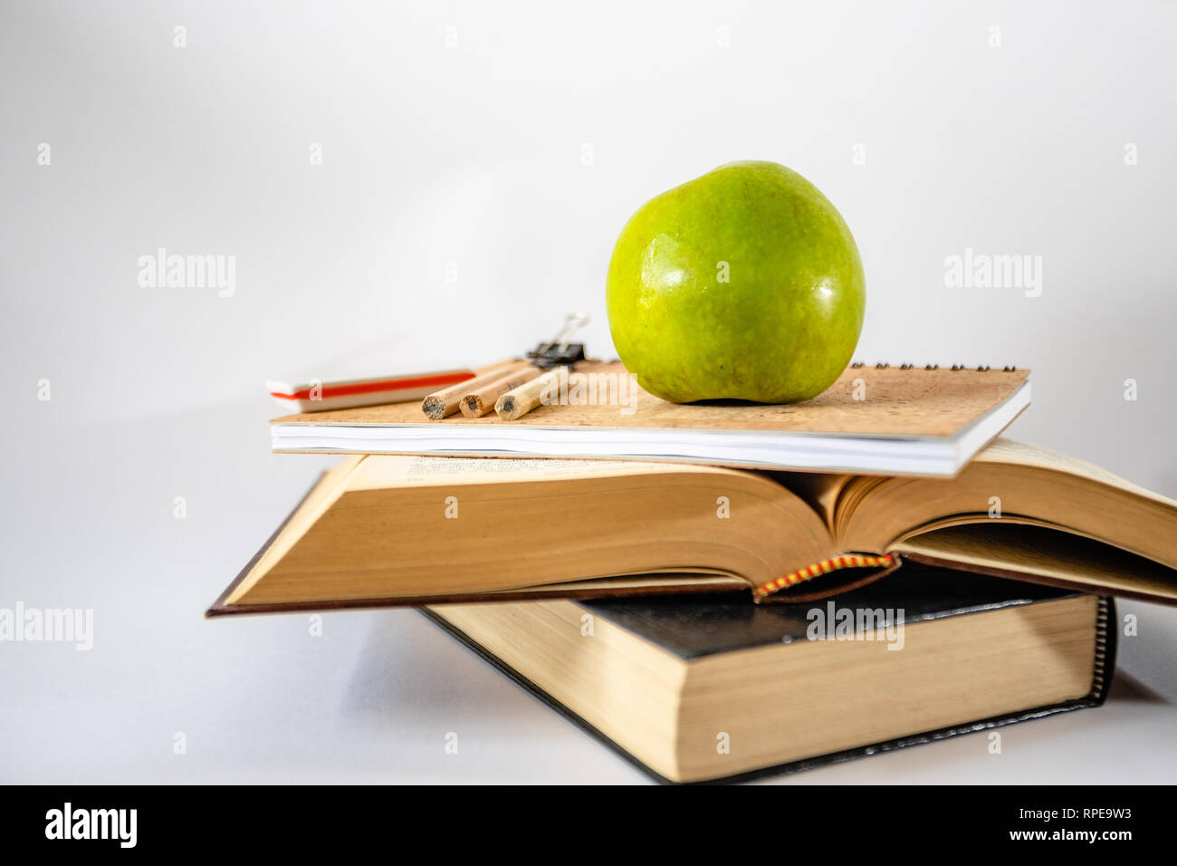 Books and apple on white background Stock Photo - Alamy
