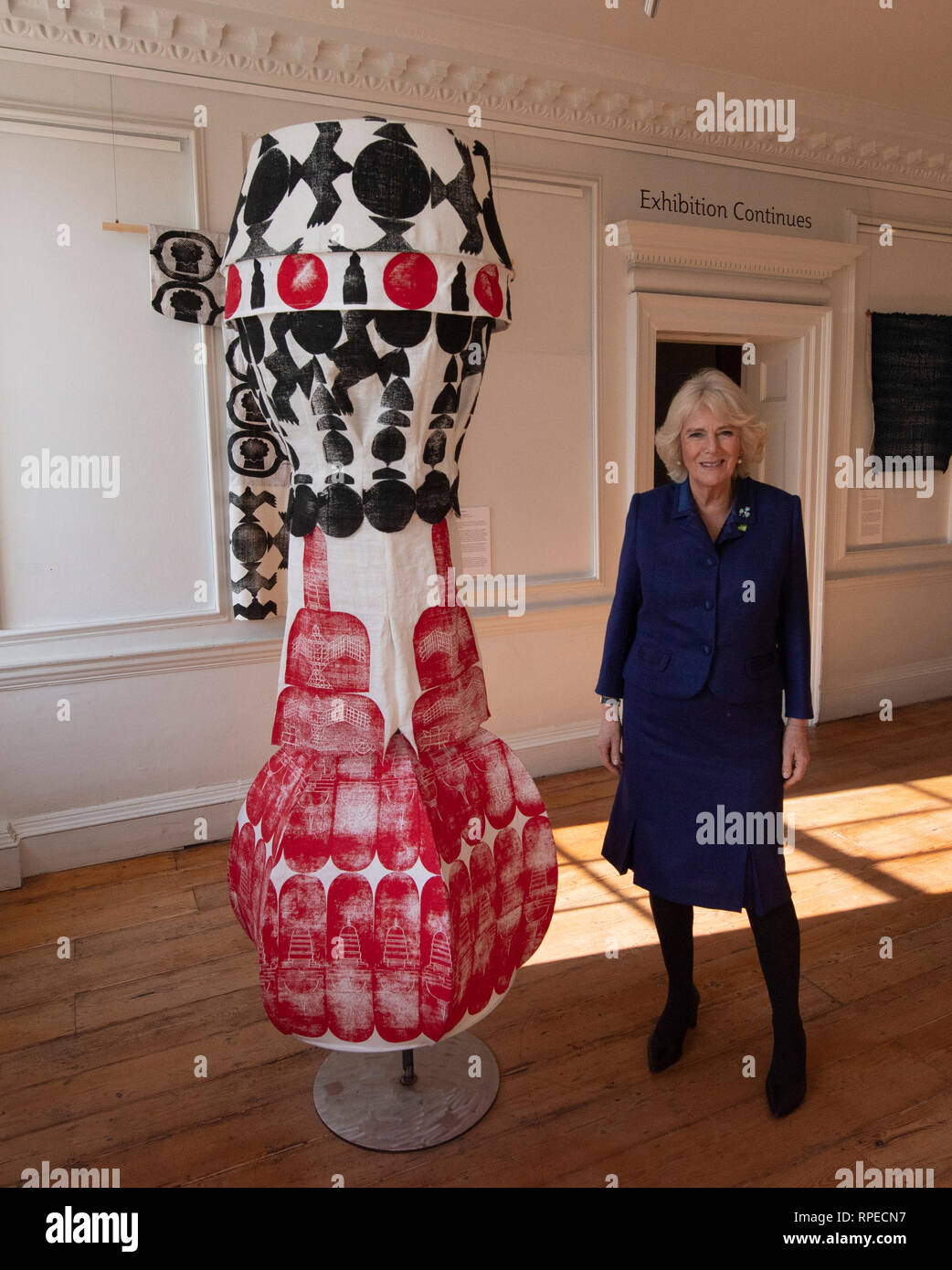 The Duchess of Cornwall looking at a coat designed by Laura Anderson ...