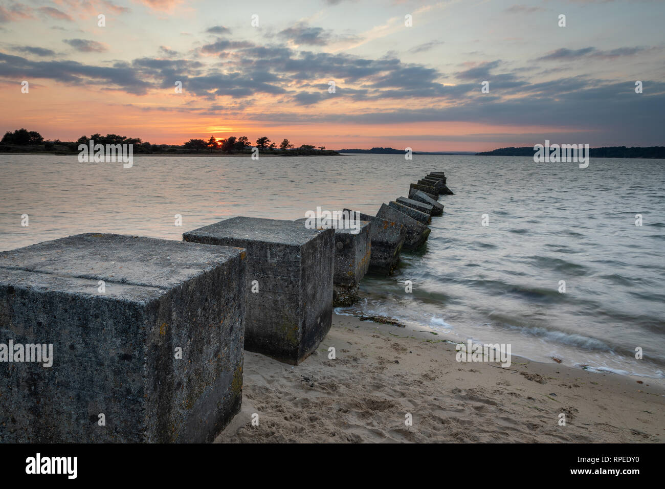 World War II tank defence blocks a Studland Bay at sunset Stock Photo ...