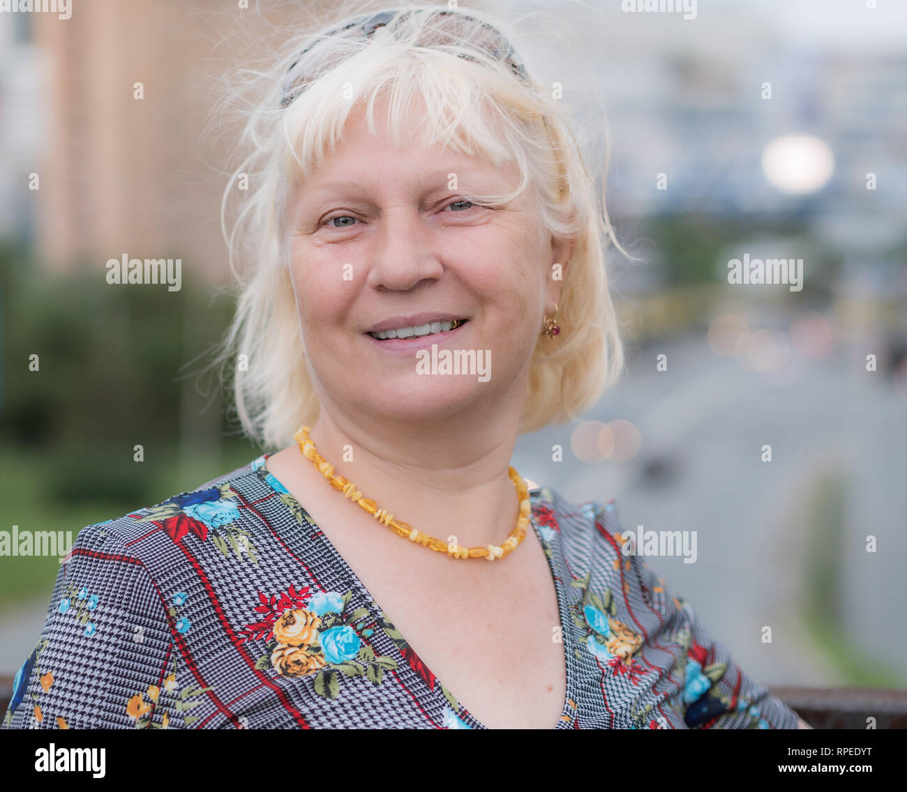 Portrait of beautiful aged woman in the park. Selective soft focus on ...