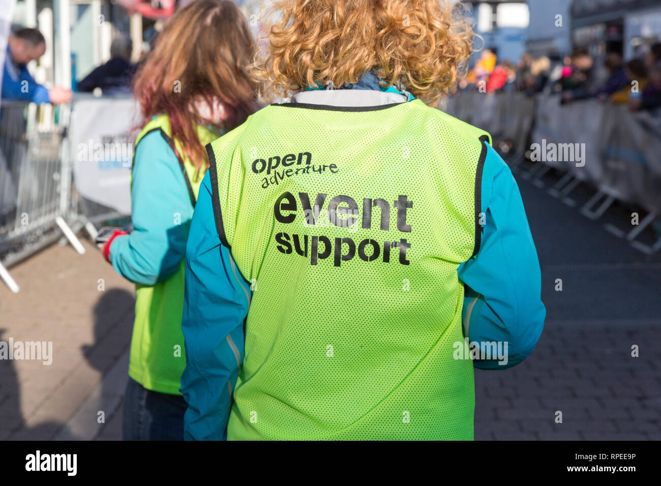A Marshal ready to guide and assist runners at a race finish Stock ...