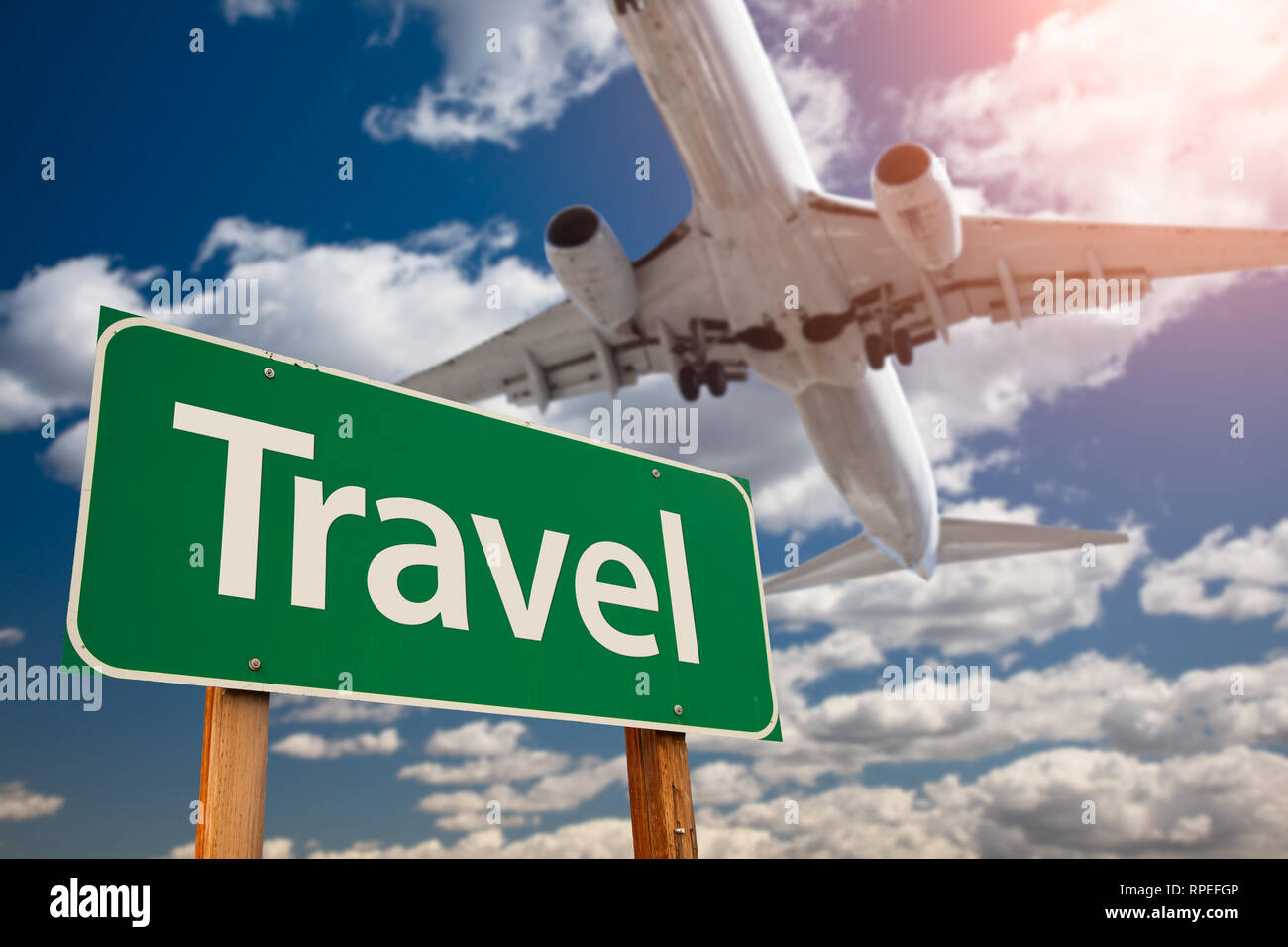 Travel Green Rodd Sign with Airplane Flying Above Stock Photo - Alamy