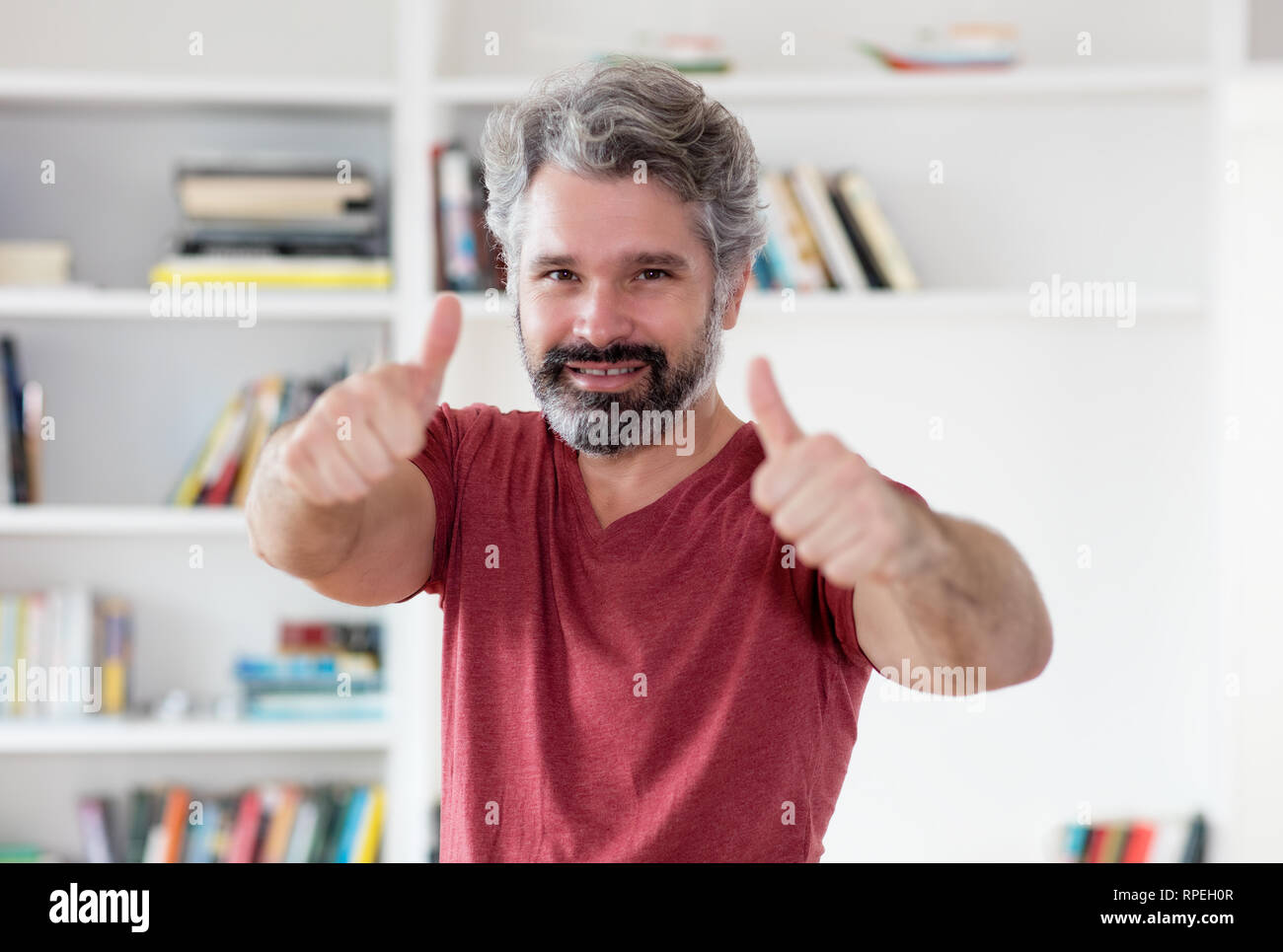 Handsome german middle aged man with grey hair showing both thumbs up ...