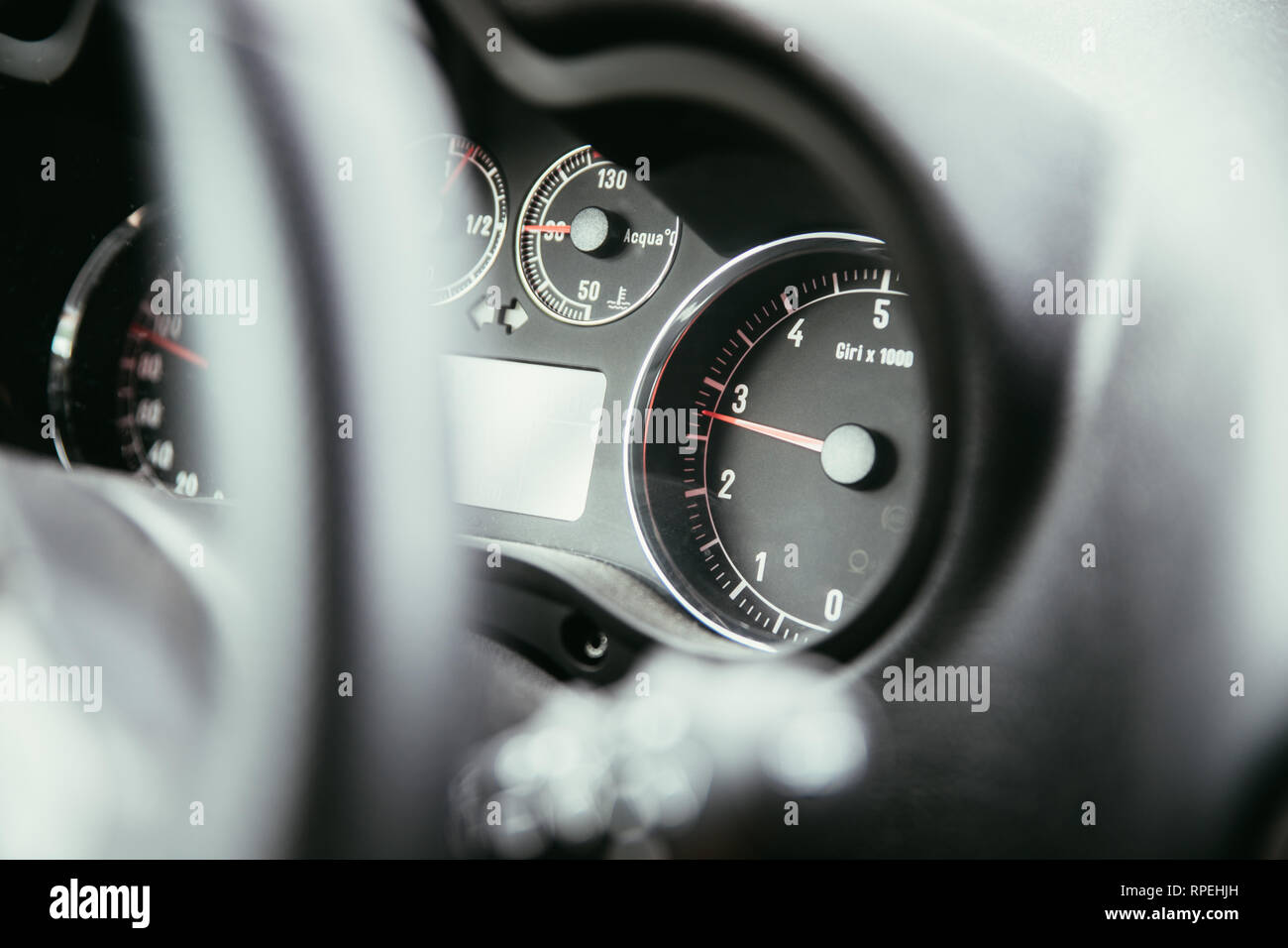 Sports car dashboard and steering wheel with tachometer and fuel ...