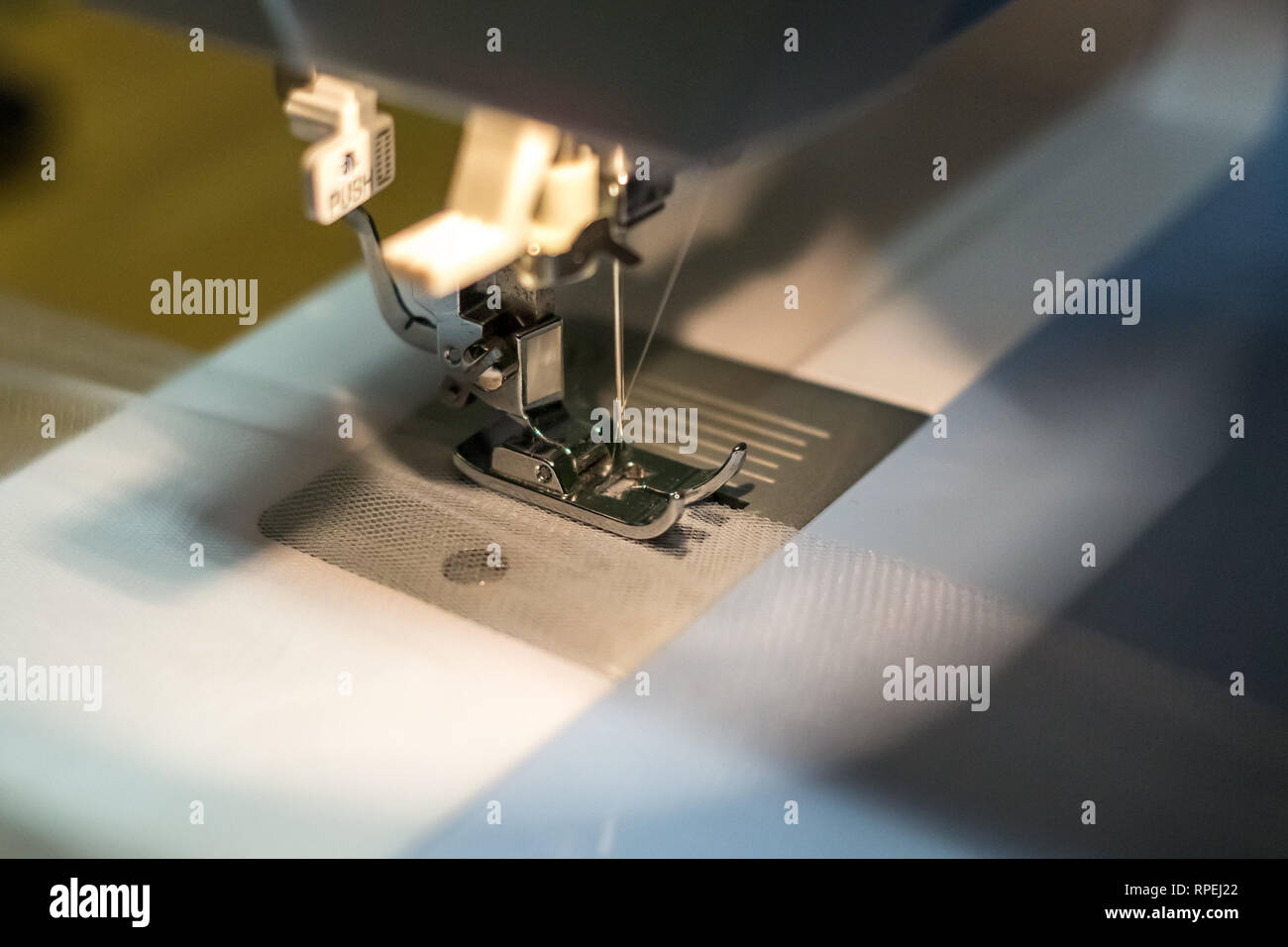 close up mechanism of sewing machine foot with needle and thread Stock ...
