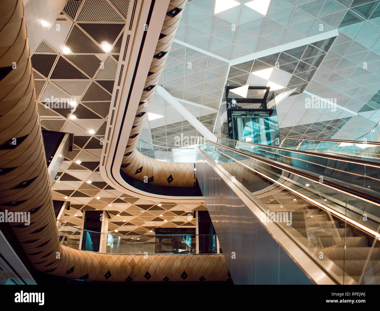 Modern airport terminal escalator up to the departures area. Waiting ...