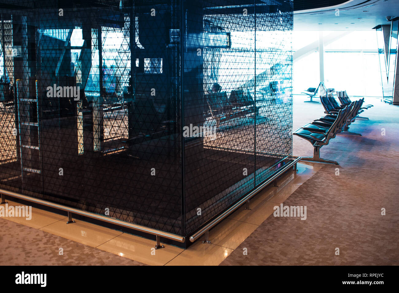 Modern airport terminal escalator up to the departures area. Waiting ...