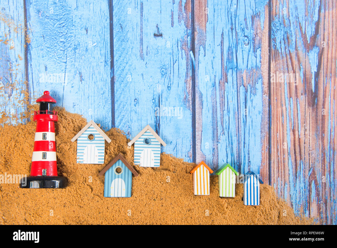 Lighthouse and beach huts in sand at the beach Stock Photo - Alamy