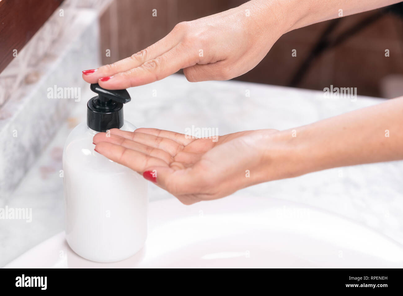 Female hands applying liquid soap, close up Stock Photo - Alamy