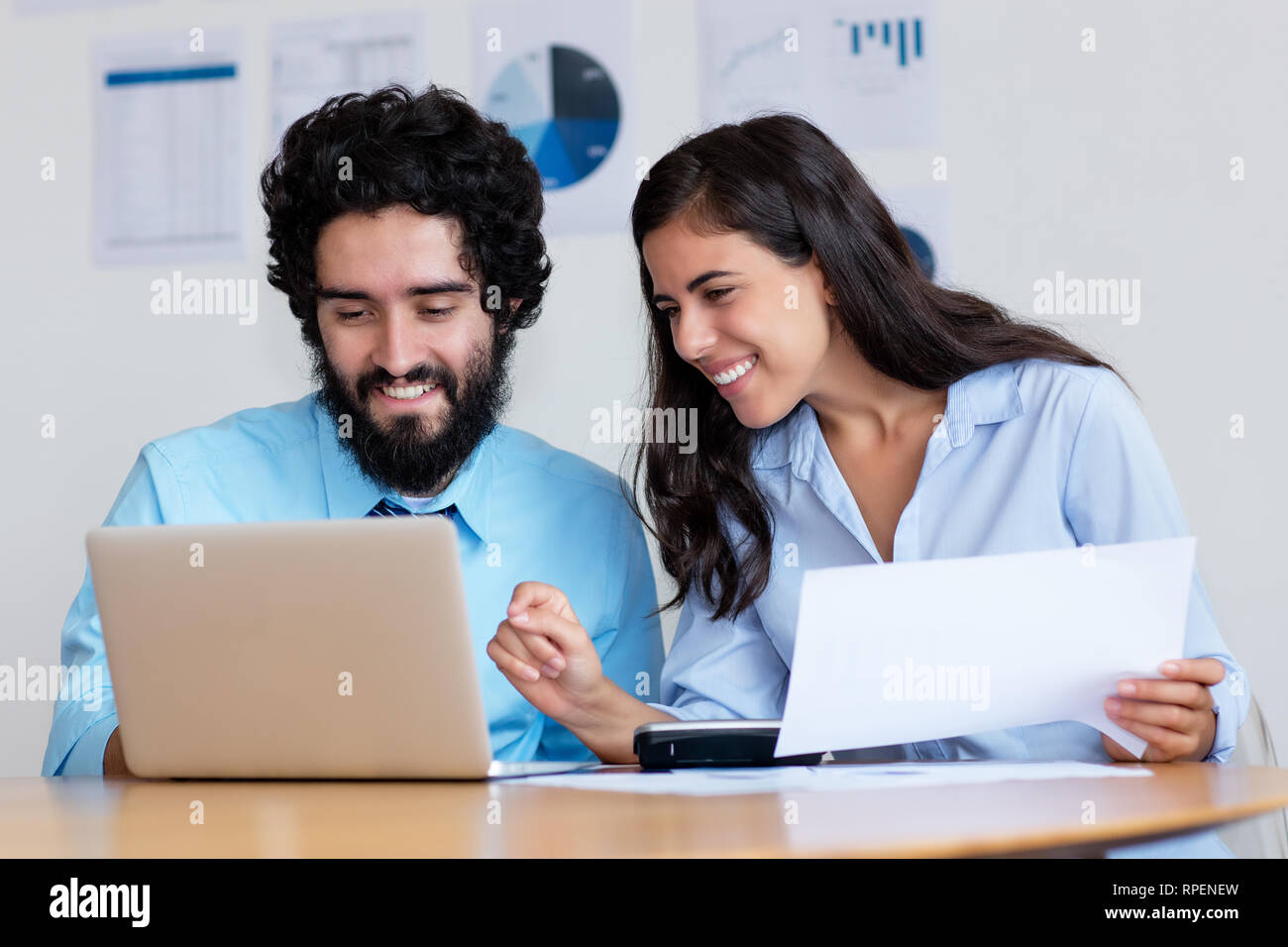 Happy arabic business team at work at desk at office of company Stock ...