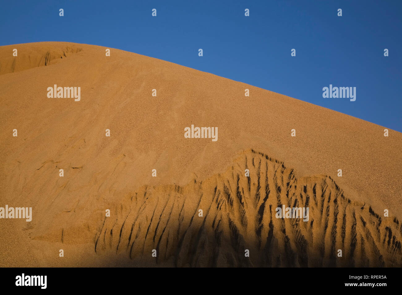 Mound of sand around sunset in a commercial sandpit Stock Photo - Alamy